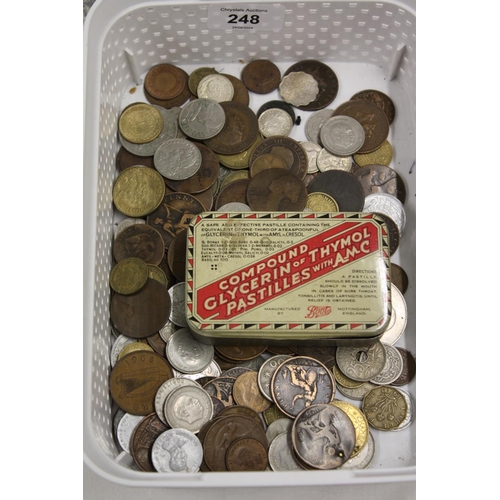 A collection of worldwide coins including a tin of silver coins