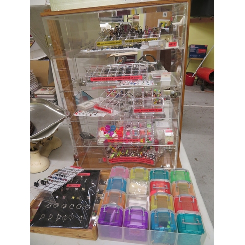 Large collection of piercing jewellery in display case and boxes