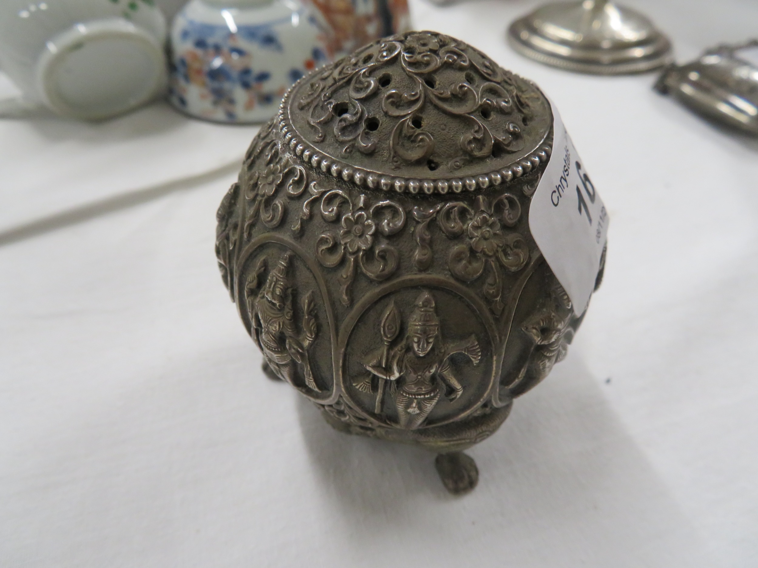 Indian chased white metal pepper pot with figures in relief to body, on ...
