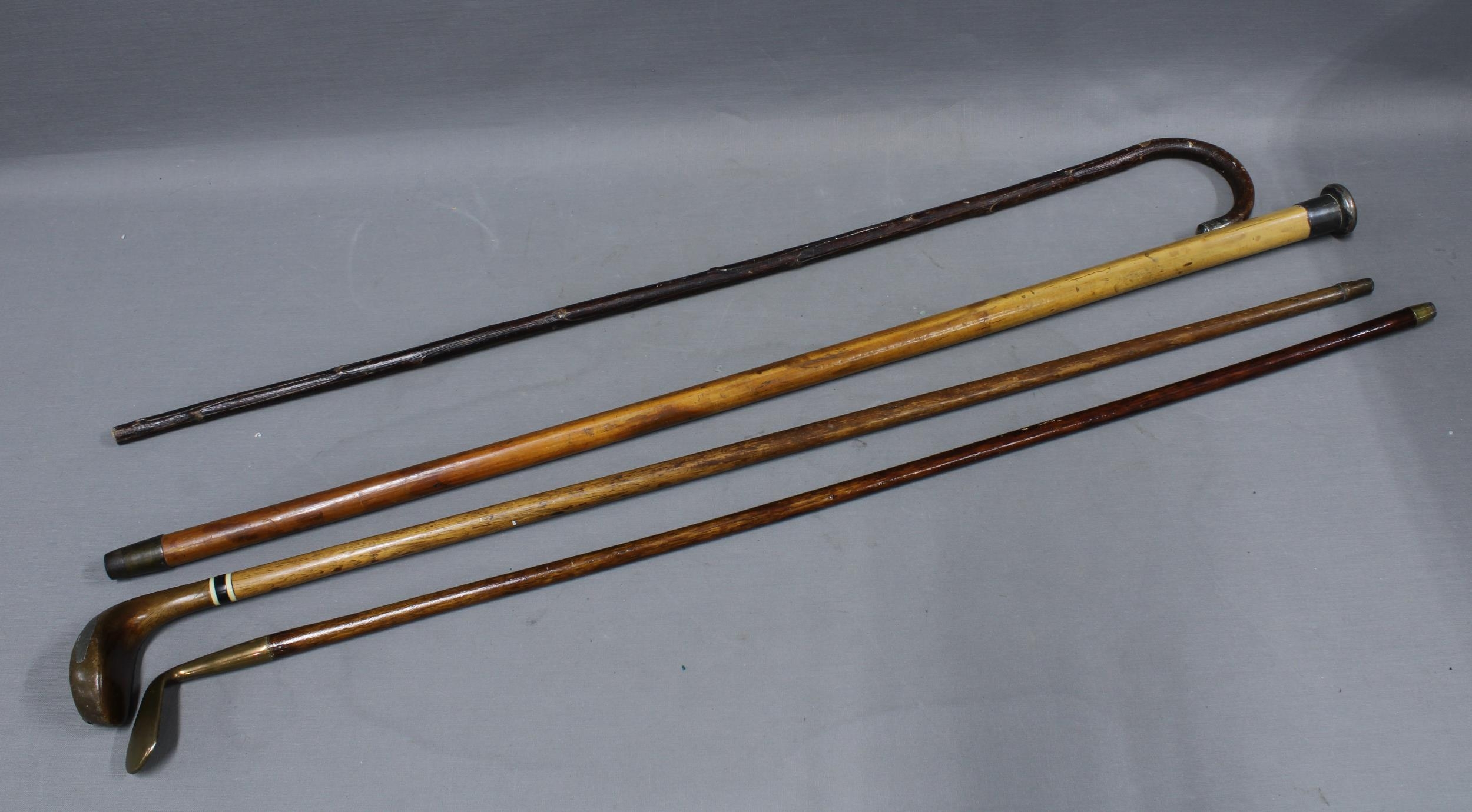 Two early 20th century Sunday golf walking sticks and two walking canes ...