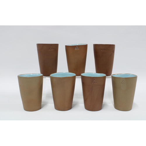 Set of seven studio pottery beakers with pale blue glazed interiors (7)