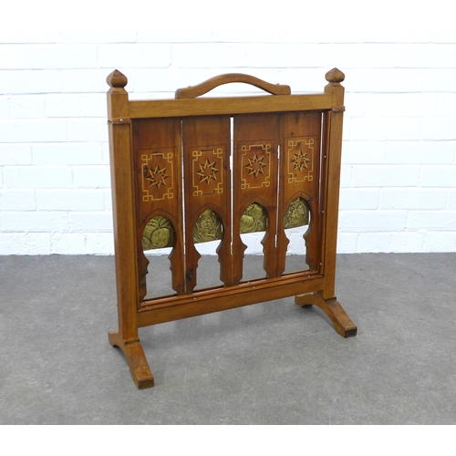 An Arts & Crafts inlaid firescreen, with embossed brass panels of ...