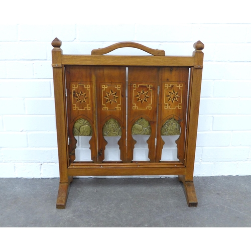An Arts & Crafts inlaid firescreen, with embossed brass panels of ...