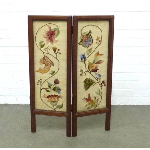 A small mahogany two fold embroidered screen, 59 x 82cm.