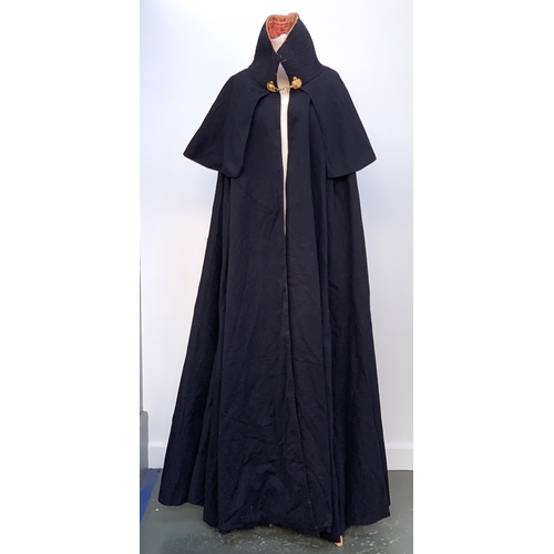A late 19th/early 20th century dark navy regimental cloak with red ...