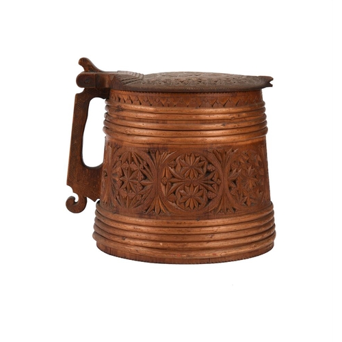 A Scandinavian carved wood tankard, c.1900 , of typical form with ...