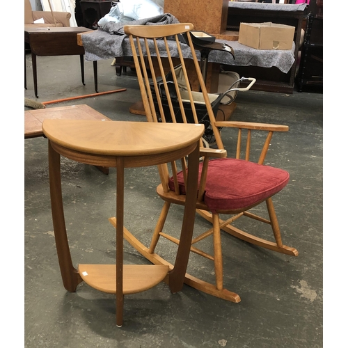 A stick back rocking chair together with a small side table