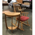 A stick back rocking chair together with a small side table
