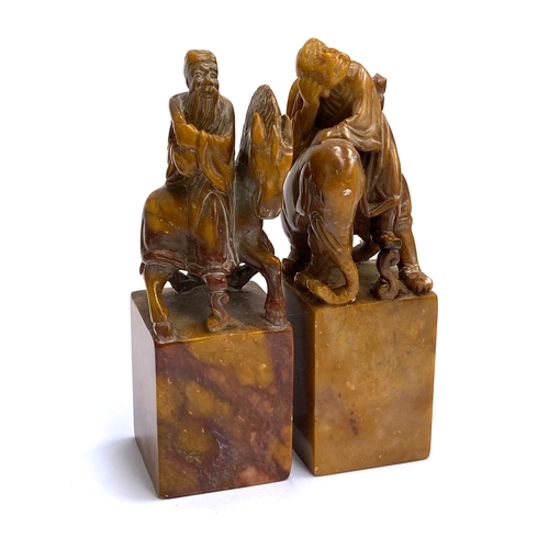 Two Chinese carved hardstone chop seals surmounted by a man riding ...