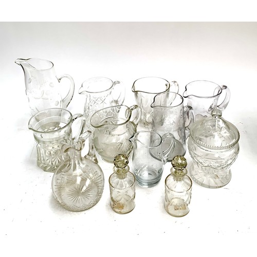 A quantity of glass jugs to include 19th century hand blown examples ...