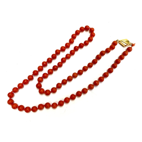 A string of good red coral beads, each bead 6mmD, knotted, fastening ...