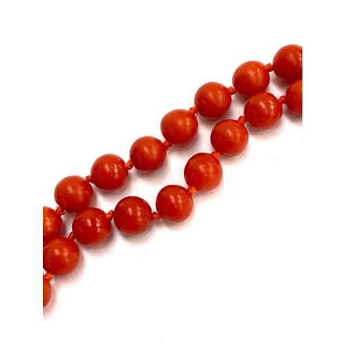 A string of good red coral beads, each bead 6mmD, knotted, fastening ...