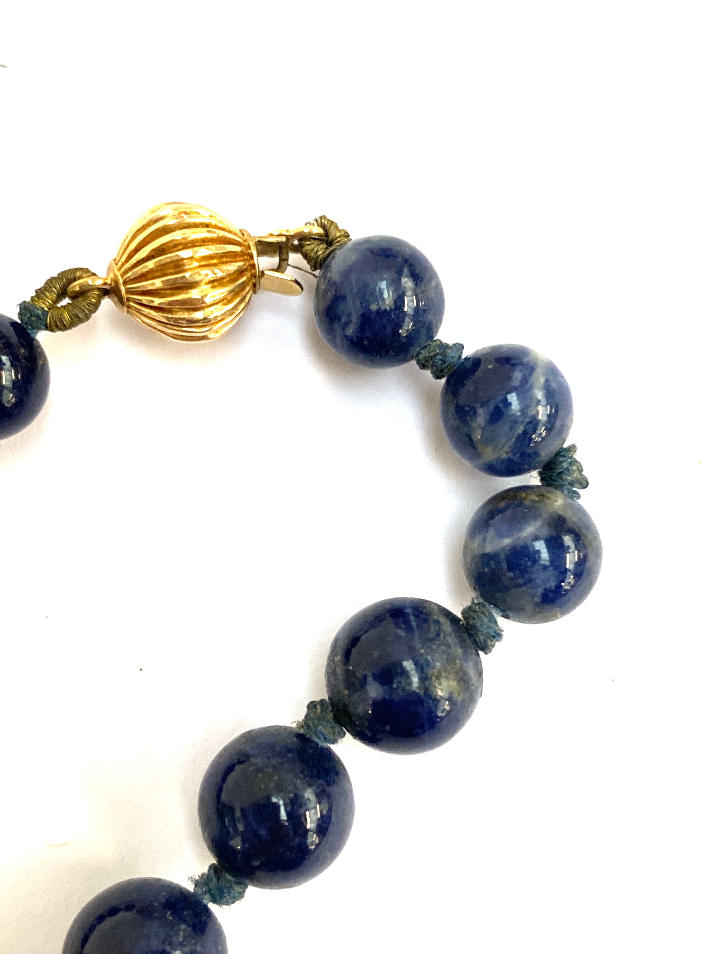 A sodalite bead necklace fastening with a 9ct gold clasp, 54cmL unclasped