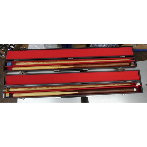Two 2 piece snooker cues in carrying cases