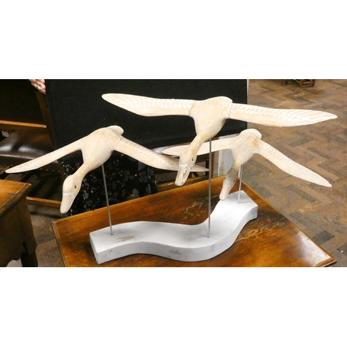 A contemporary drift wood carved sculpture of three flying geese ...
