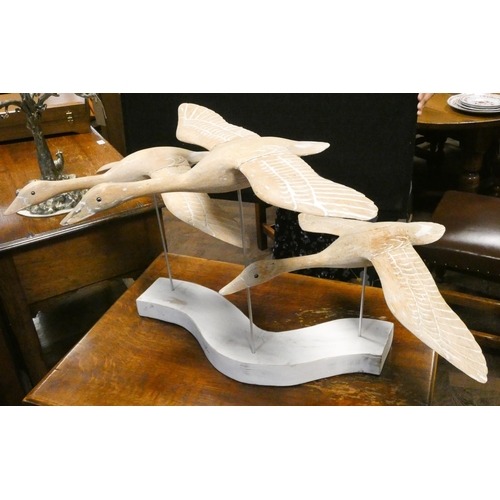 A contemporary drift wood carved sculpture of three flying geese ...