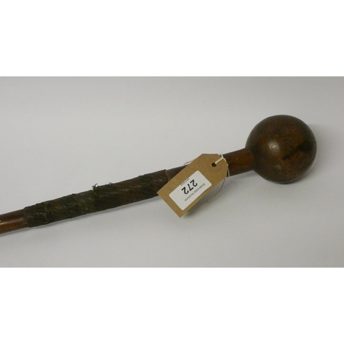 A native throwing club with wire work handle, 64cms long