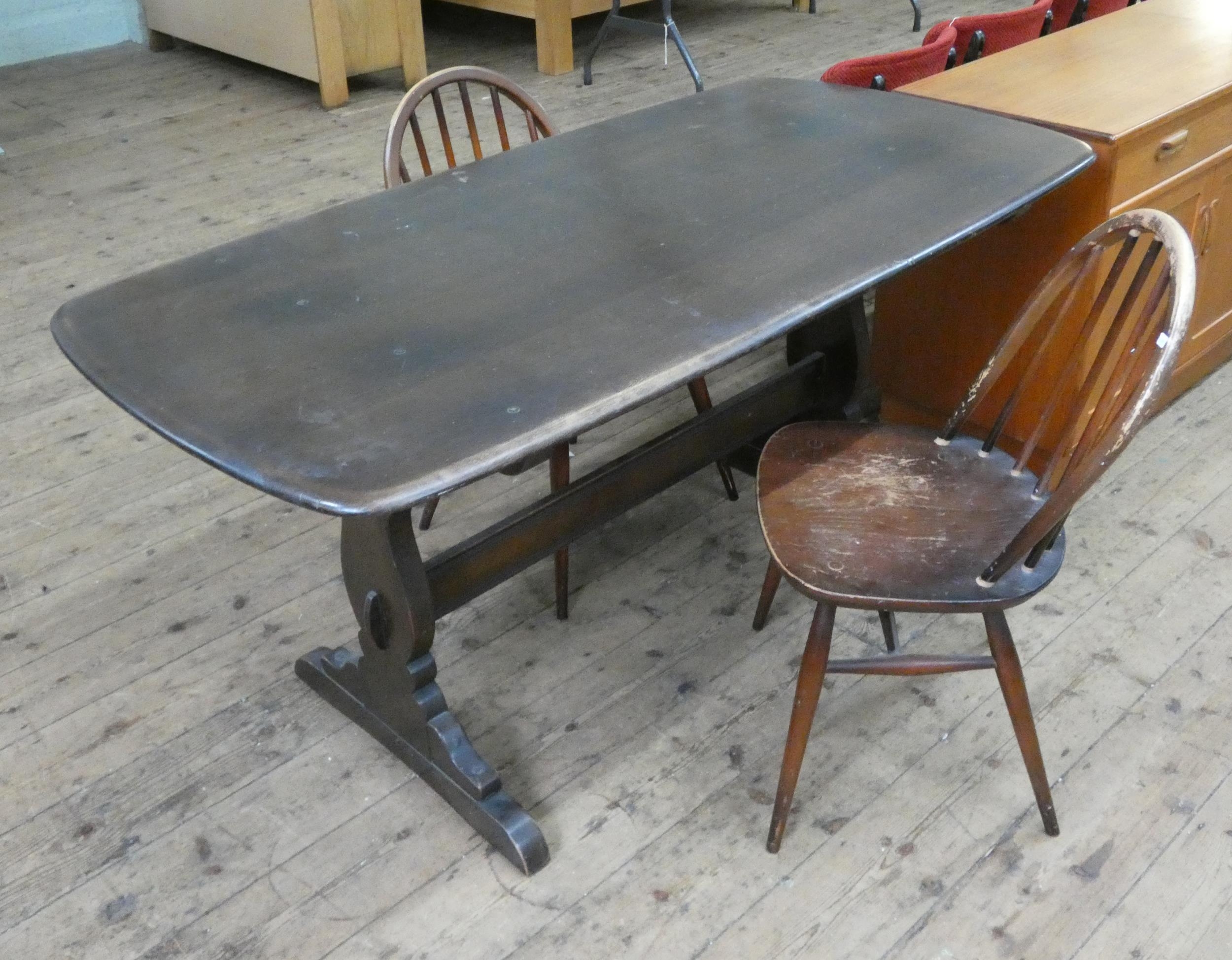 An Ercol dark oak refectory style dining table 5' x 2'6 and a pair of ...
