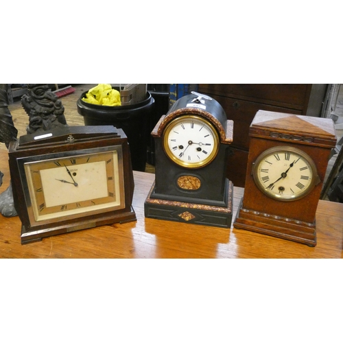 A striking black marble mantle clock and two mantle clocks in oak cases