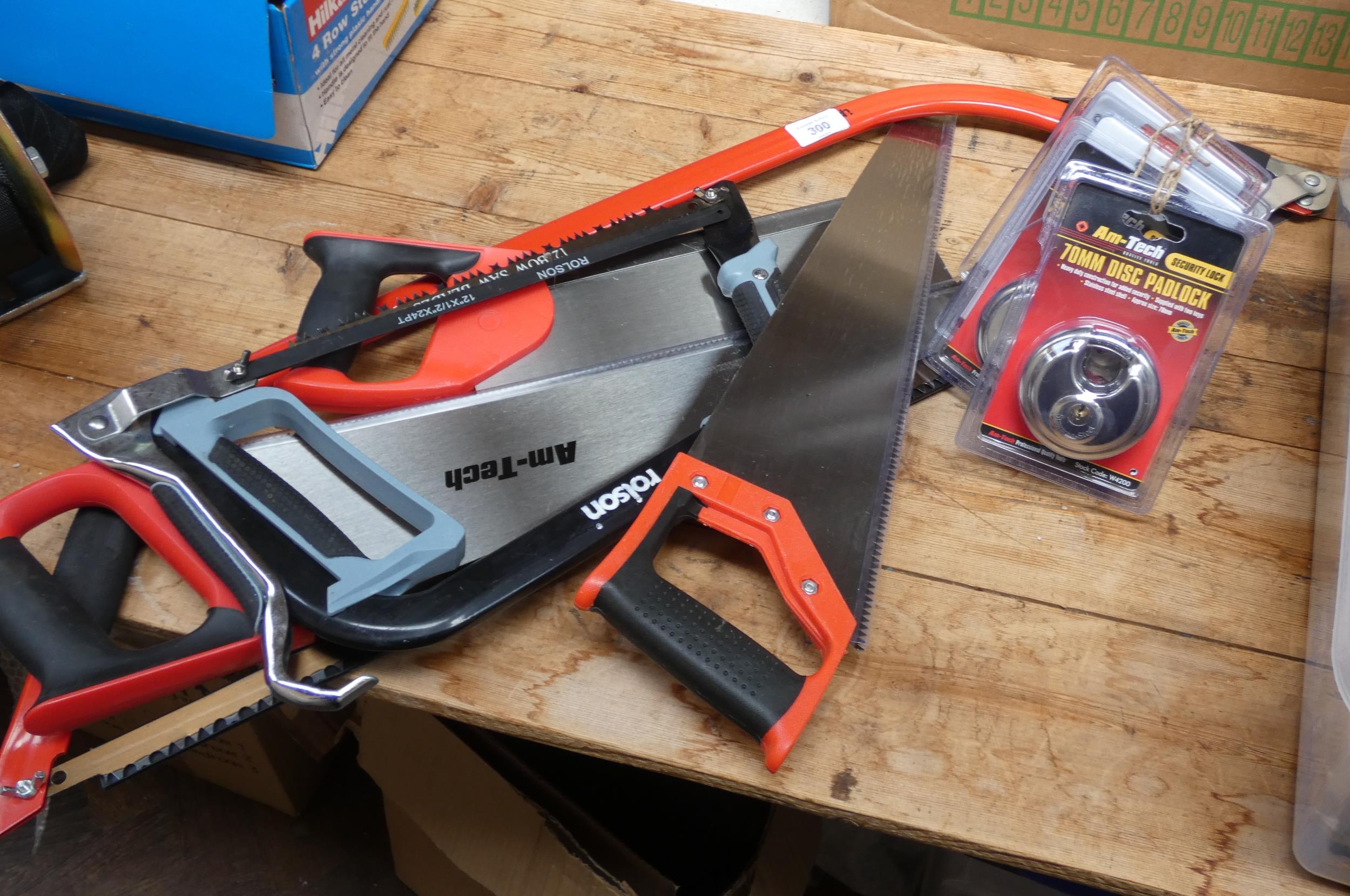 Five assorted hand saws all new and four disc padlocks