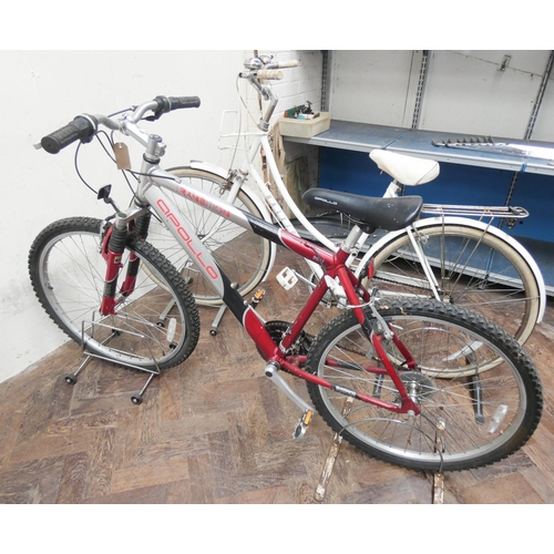 A red and silver Apollo gents bicycle with front suspension