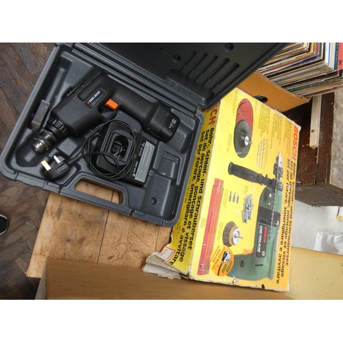 A large Bosch electric hammer drill and a Black and Decker 7.2 volt ...