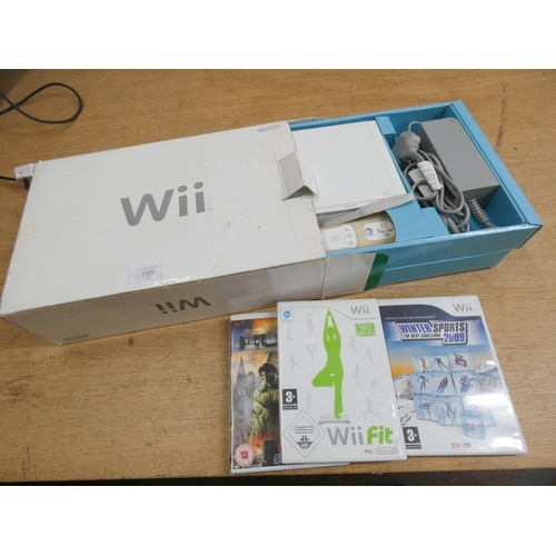 A boxed Nintendo Wii console with accessories and three disc games