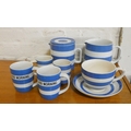 Two blue and white Cornish ware jugs, a large cup and saucer and four mugs