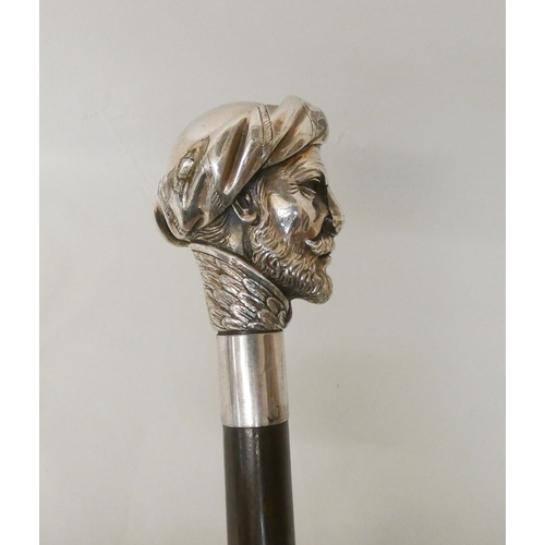 An Edwardian walking cane with silver topped Turks head finial