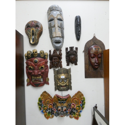 Nine assorted carved wood painted masks
