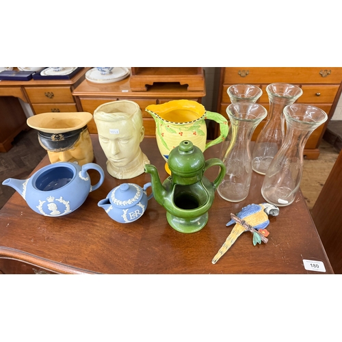 Four glass advertising bottle type vases together with Wedgwood blue ...