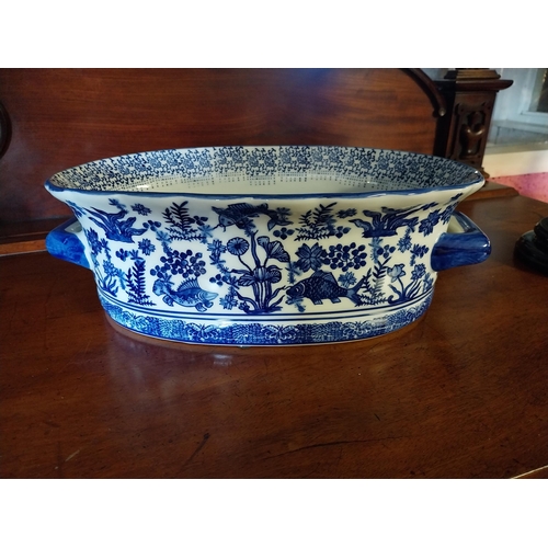 Blue and white ceramic foot bath {13 cm H x 41 cm W x 24 cm D}.