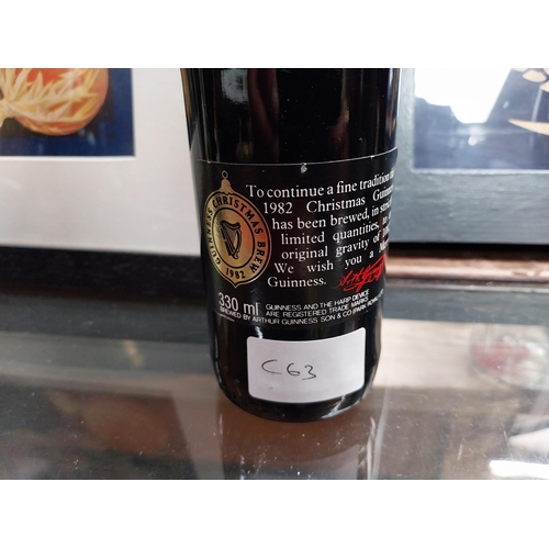 Three bottles of Guinness with Christmas labels.