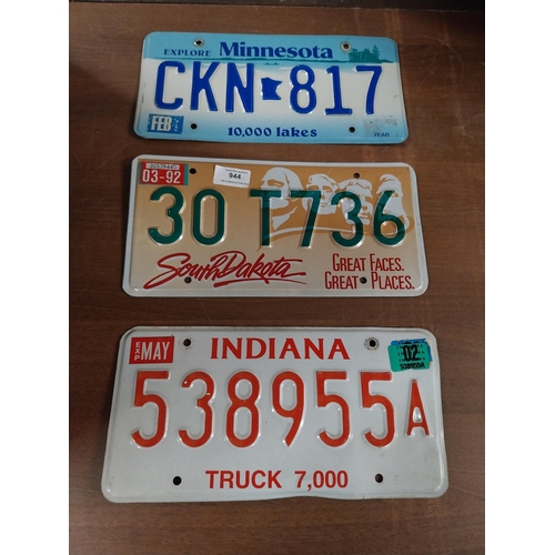 Three American number plates - Indiana Minnesota and South Dakota.
