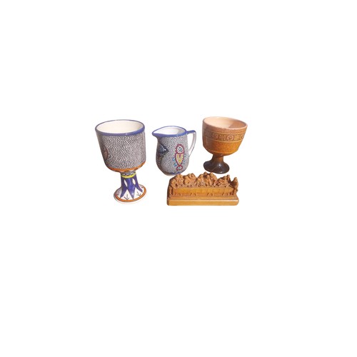 Two ceramic goblets, jug and wooden depiction of The Last Supper.