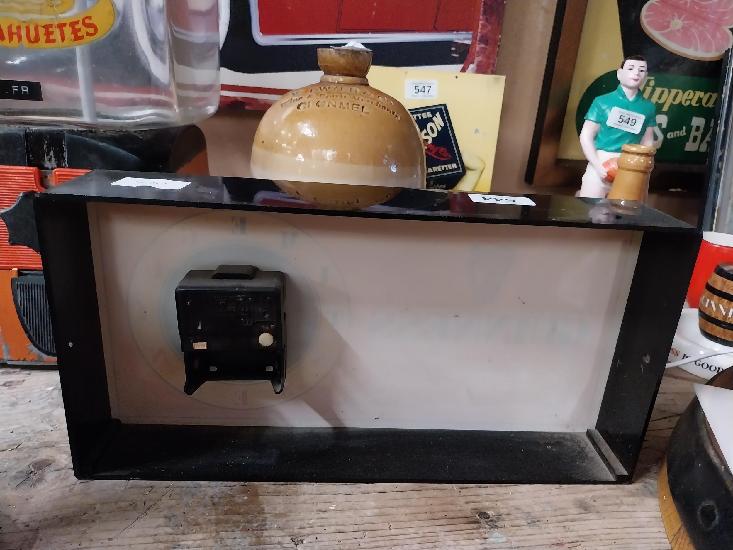 Guinness perspex battery operated clock. {18 cm H x 35 cm W x 7 cm D}.
