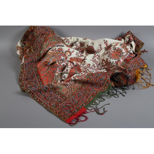 A 19th century square woven Norwich shawl, the cream centre with ...