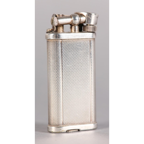 A DUNHILL 'UNIQUE' LIFT ARM PETROL LIGHTER No. 484316 engine turned, silver plated, signed and numbe