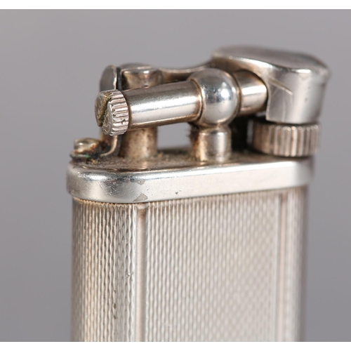 A DUNHILL 'UNIQUE' LIFT ARM PETROL LIGHTER No. 484316 engine turned ...