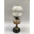 A 19th century oil lamp by T. Rowatt and sons, having an etched and ...