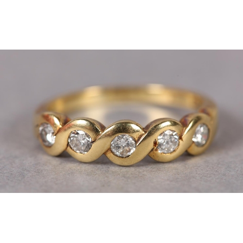 A DIAMOND FIVE STONE RING in 18ct gold, the brilliant cut stones rub ...