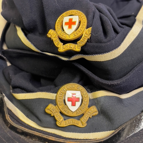 A British red Cross uniform comprising an apron with embroidered red ...