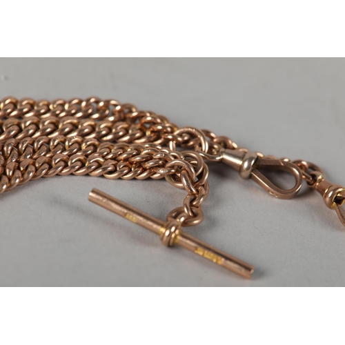 A GEORGE V DOUBLE WATCH GUARD CHAIN in 9ct rose gold, graduated curb ...