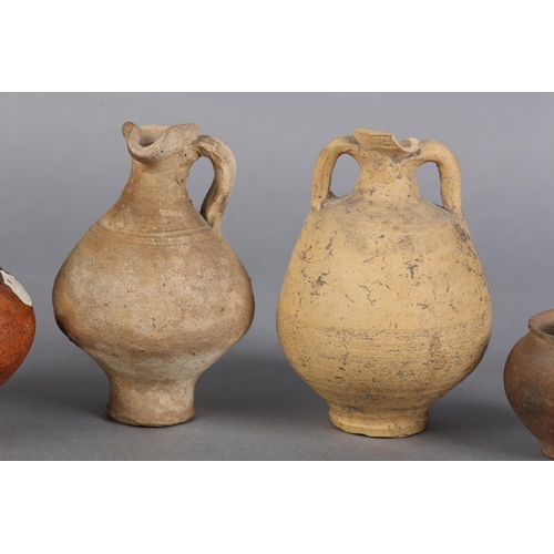 A ROMAN EARTHENWARE POT with everted rim and ovoid body, 5cm high, a ...