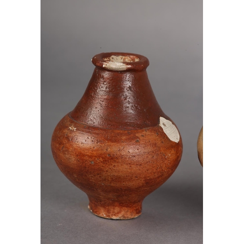 A ROMAN EARTHENWARE POT with everted rim and ovoid body, 5cm high, a ...