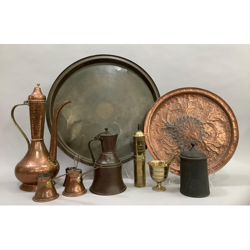 A Turkish copper coffee pot, three copper ladles, a smaller copper pot ...