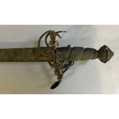 A heavily corroded sword with elaborate basket-like guard, probably a ...