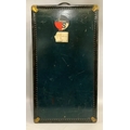 A Watajoy steamer trunk with studs and brass tone hardware carrying ...