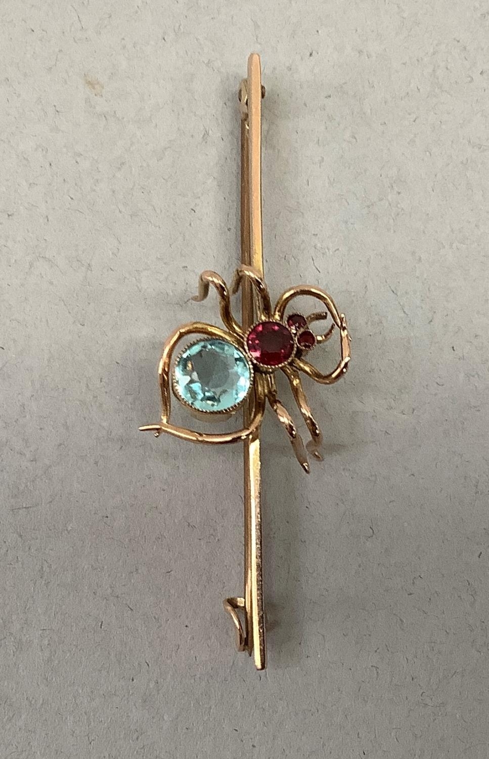 A George V spider bar brooch in 9ct gold collet set with red and pale ...