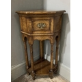 A small oak corner table of canted form having a small drawer to the ...